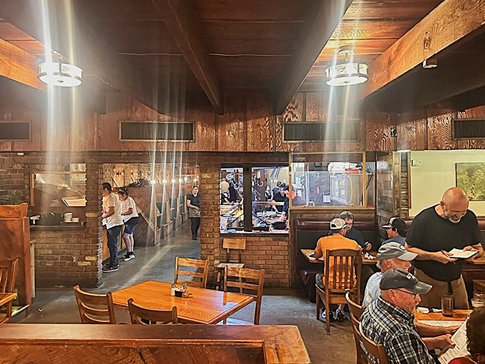 Another angle of this timeless interior where wood beams and warm lighting set the stage for culinary magic.