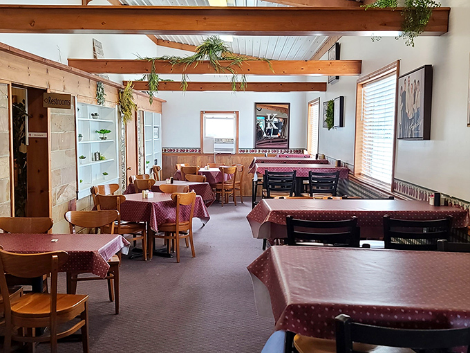 Sunlight streams into this peaceful dining space, where burgundy tablecloths await the next round of satisfied customers.