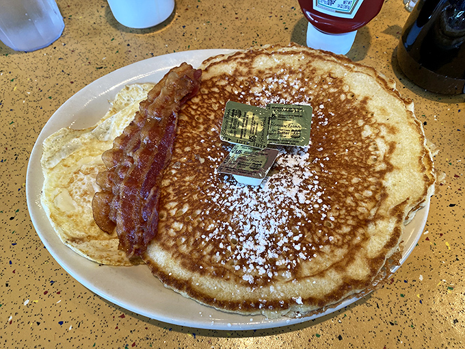 A pancake so perfectly golden it deserves its own Instagram account, with bacon playing the essential supporting role.