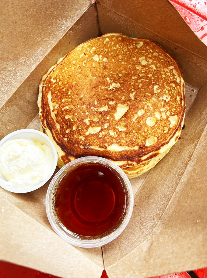 Pancakes served in a box like the treasure they are. The maple syrup waiting patiently for its moment of glory.