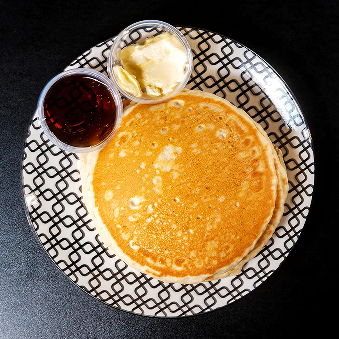 Pancakes that float like clouds on a geometric-patterned plate. The butter slowly melting into those perfect circles is nature's way of saying "good morning" to your taste buds.