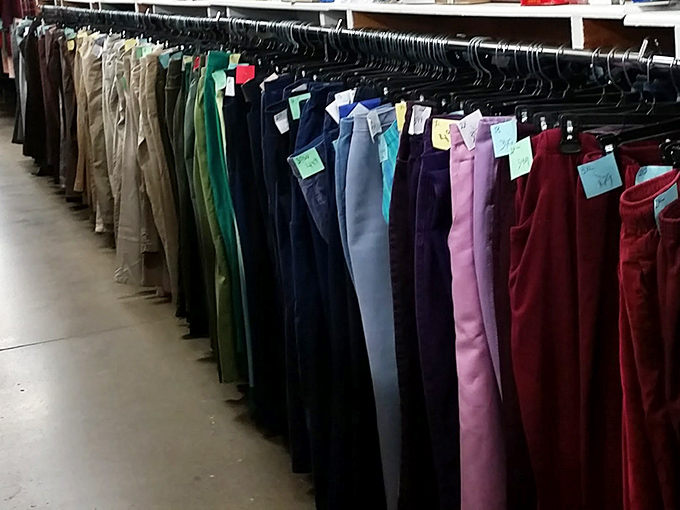 A rainbow of slacks arranged by size and color, each pair holding the promise of "maybe these will actually fit" for hopeful shoppers.
