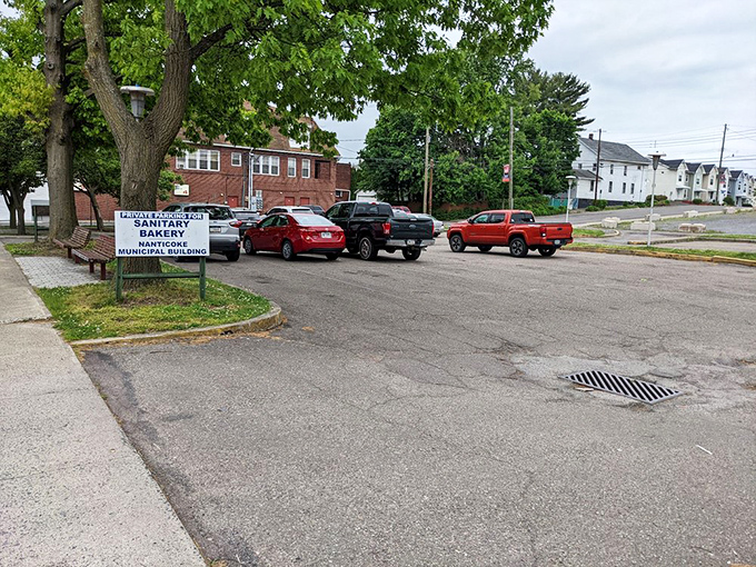 The town sign reveals Sanitary Bakery's place in the community fabric of Nanticoke, as essential to local identity as the municipal building itself.