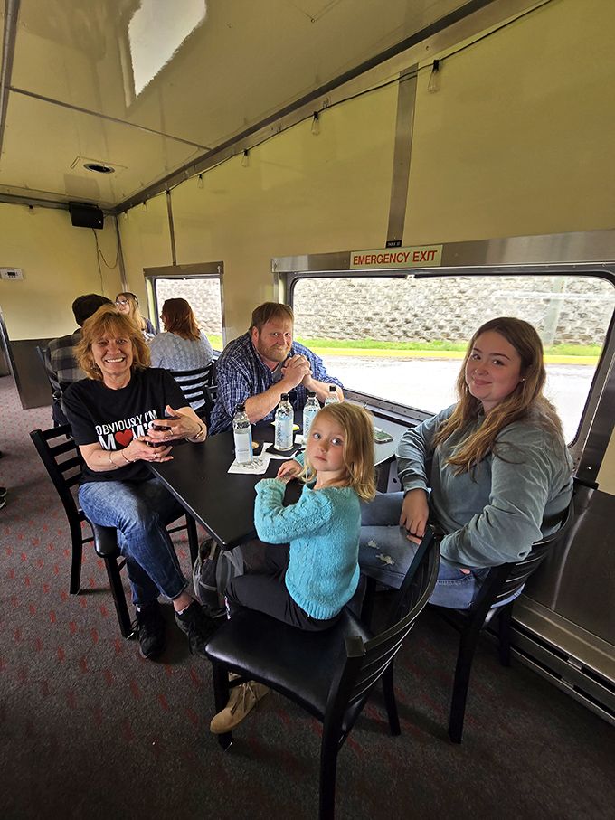 Modern comfort meets vintage travel as families enjoy refreshments while the Indiana countryside rolls past their window like a living painting.