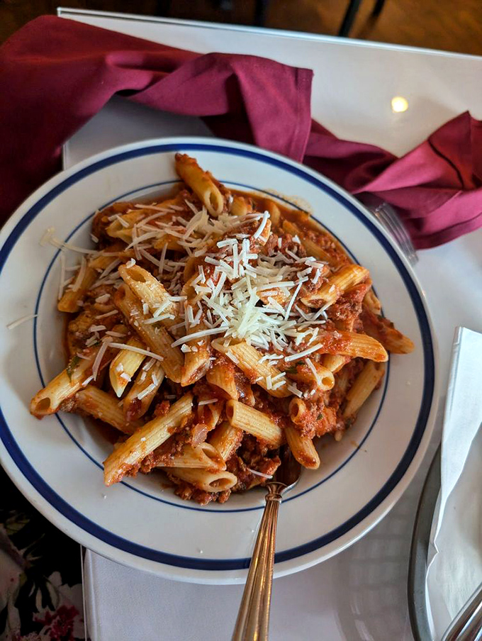 Penne bolognese piled high with meat sauce and cheese, the kind of dish that makes you loosen your belt preemptively.