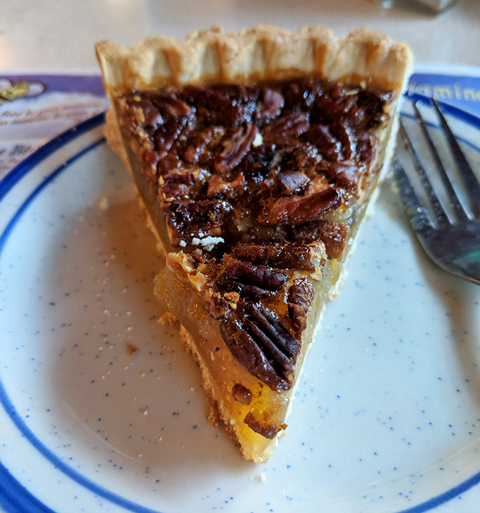 Pecan pie that strikes the perfect balance between gooey and structured—the kind that makes you seriously consider ordering a whole one "for later."