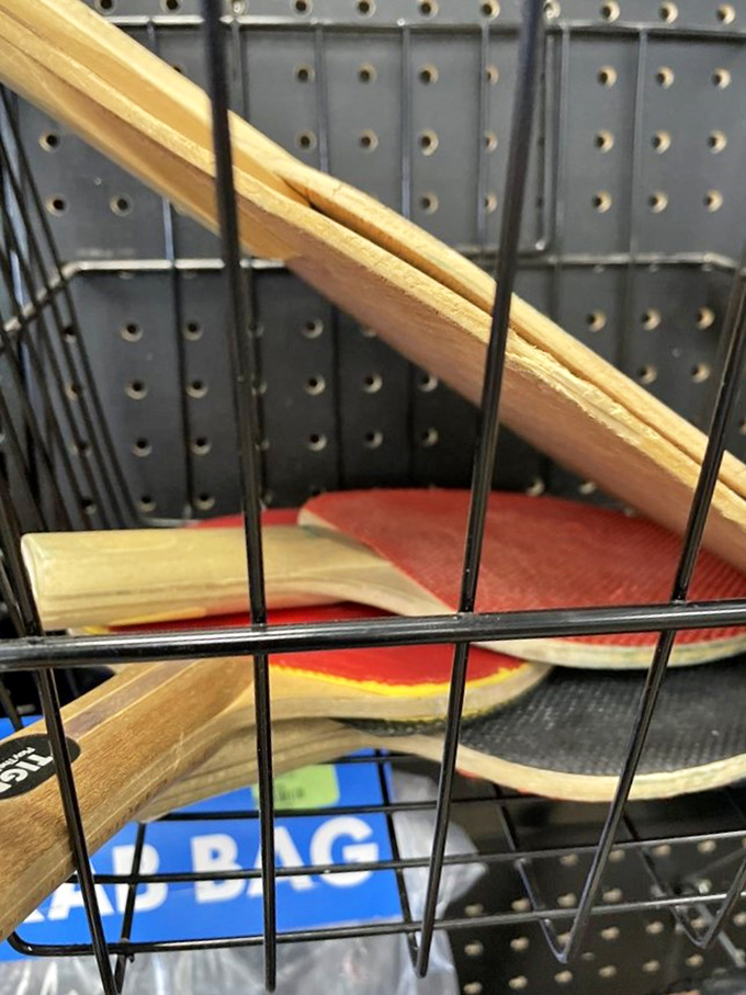 Ping pong paddles and sports equipment nestled in wire baskets—proof that someone else's abandoned hobby can become your new weekend passion.