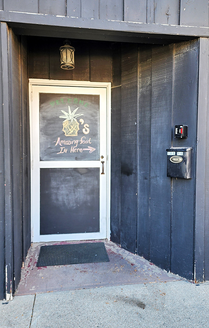 "Amazing food in here" promises this unassuming doorway, where culinary delights await without the pretentious pricing of big-city establishments.