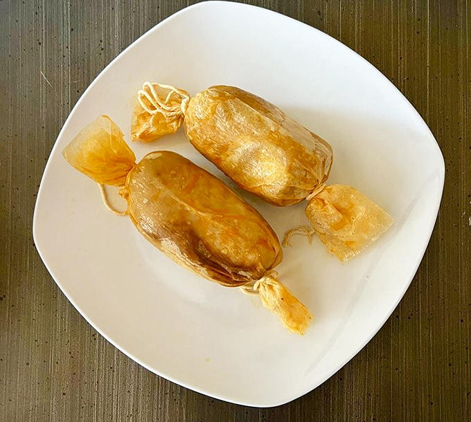 Tamales still wearing their corn husk jackets, golden treasures waiting to be unwrapped like the culinary Christmas presents they truly are.