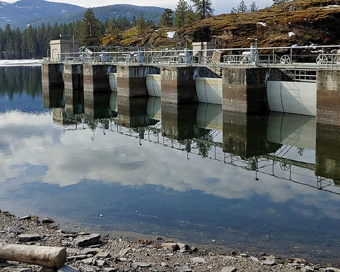 The Post Falls Dam stands as both functional infrastructure and accidental art installation, its reflection creating perfect symmetry on calm days.