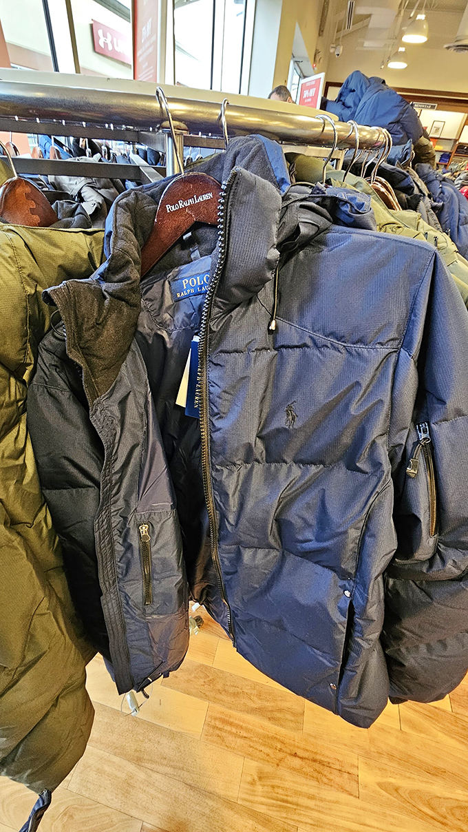 Puffer jackets standing at attention, ready for winter duty. Ralph Lauren's navy blue option practically whispers, "I'll make you look sophisticated while freezing."