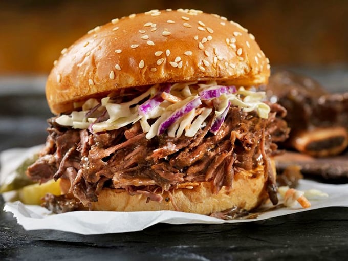 A pulled pork sandwich that's practically architectural in its construction. Tender meat, tangy slaw, and a bun that somehow contains this beautiful mess.