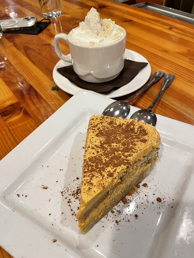 A slice of tiramisu cake that makes coffee jealous. The dusting of cocoa powder is like the first light snow on an Alaskan mountaintop.