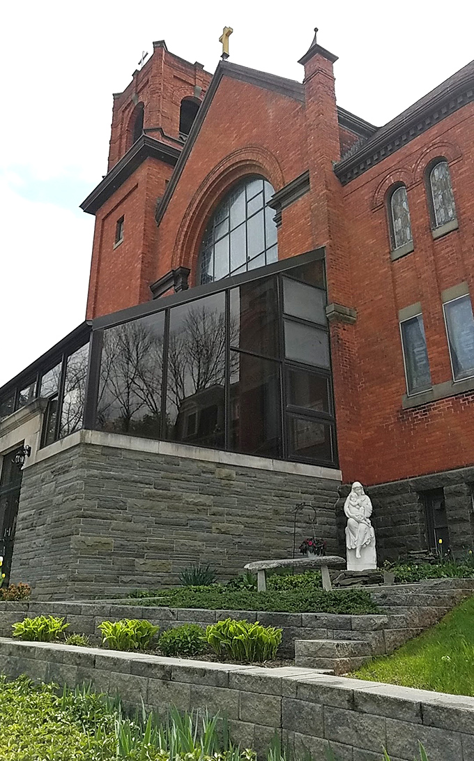 Queen of Peace Church combines historic architecture with modern additions. That red brick has witnessed generations of community gatherings.