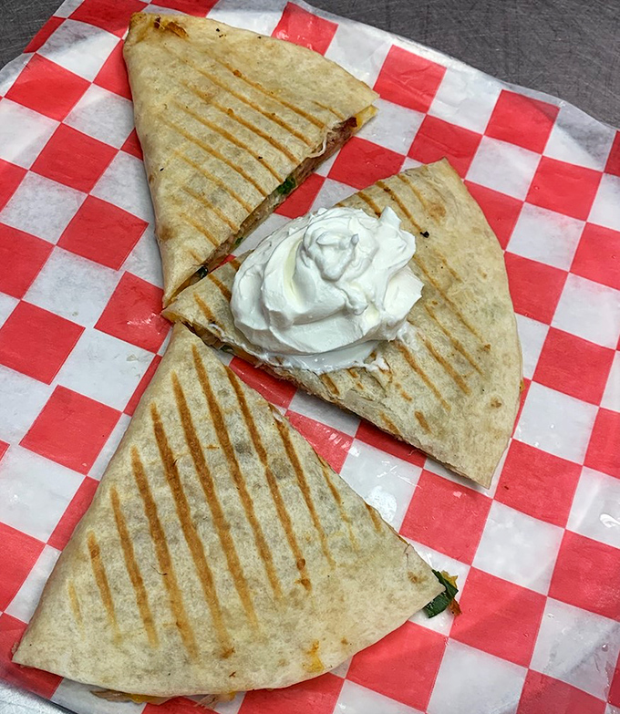 A quesadilla that bridges cultures with smoky diplomacy. The grill marks are like a roadmap to flavor country.