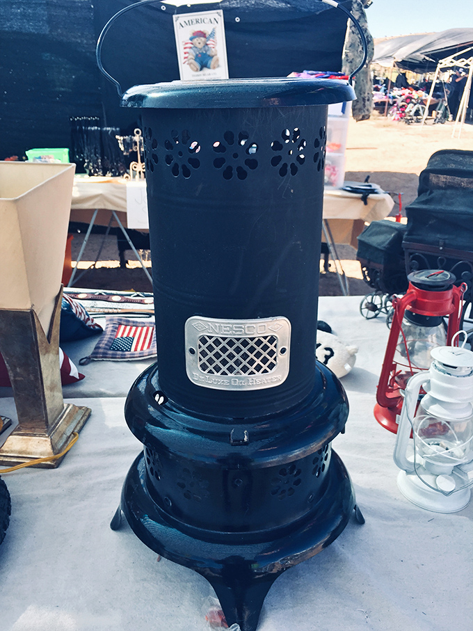An old-school Perfection kerosene heater stands sentinel among oil lamps, ready to warm both a room and memories of simpler times.