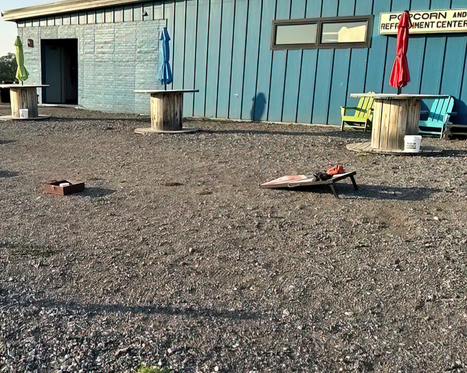 Colorful Adirondack chairs and wooden spool tables create casual gathering spots outside the refreshment center for pre-show socializing.