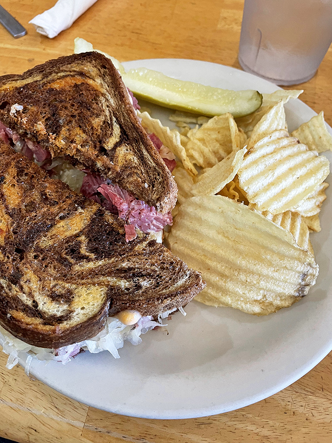 A Reuben sandwich with personality &ndash; the marble rye toasted to perfection, the corned beef peeking out like it's playing hide and seek.
