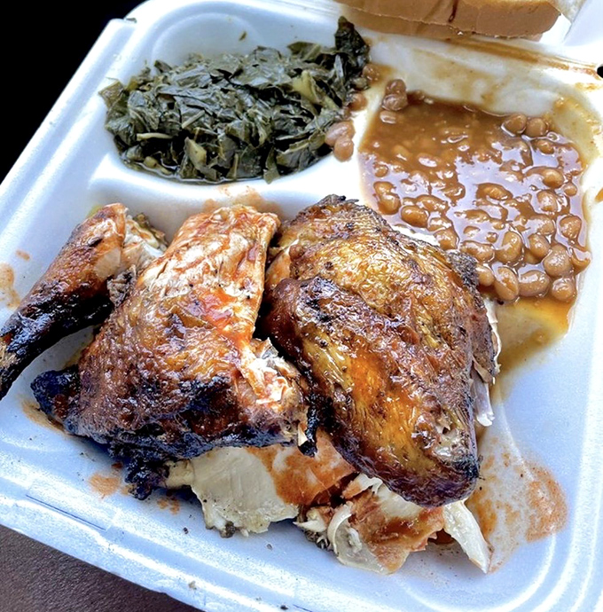 Chicken that's clearly been introduced to smoke and spice and decided to start a beautiful relationship. Those collards aren't just a side&mdash;they're a statement.
