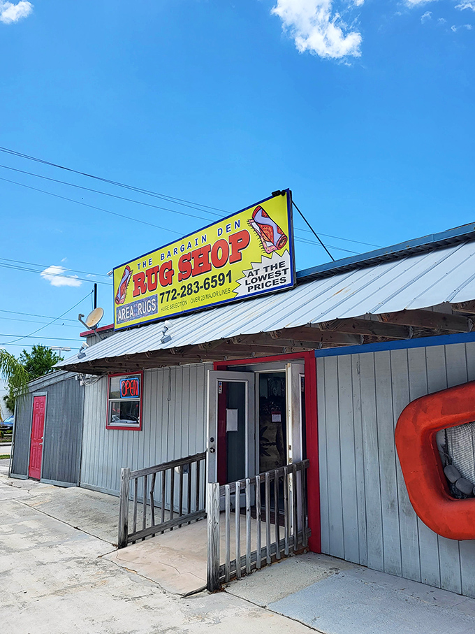 The Bargain Den Rug Shop promises "the lowest prices" beneath a cheerful crab sign&mdash;a perfect example of Florida's delightful retail eccentricity.