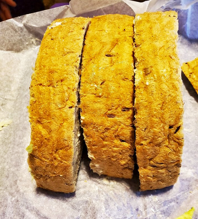 Three perfectly pressed sections of sandwich nirvana. Rye bread toasted to golden perfection&mdash;each bite a harmony of crunch and comfort.