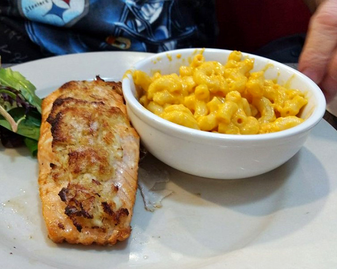Perfectly seared salmon keeping unexpected company with mac and cheese&mdash;a friendship we didn't know we needed until now.