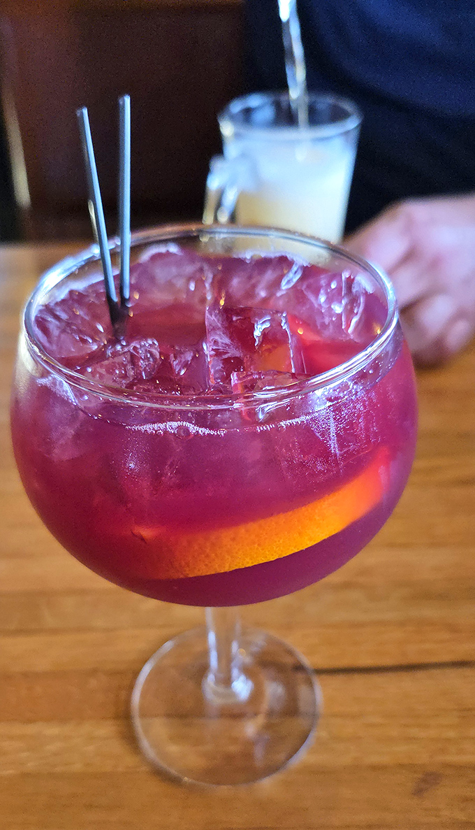 A ruby-red sangria that's dressed better than most people at formal events, garnished with citrus and promising fruity refreshment.