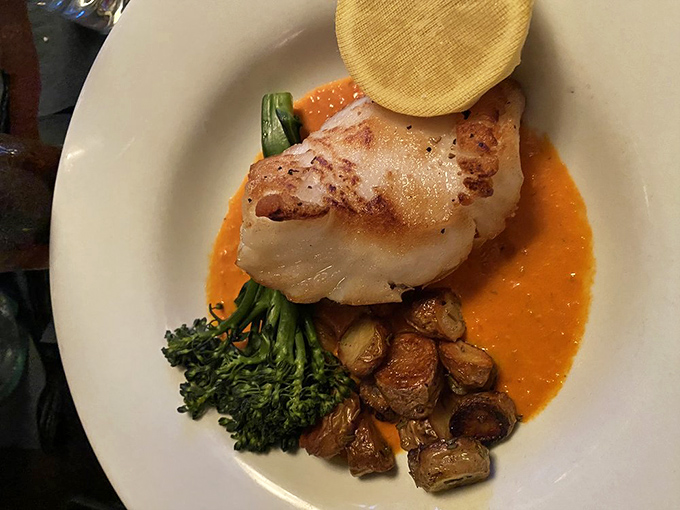 Sea bass elevated beyond mere fish status, swimming in a sauce so good you'll be tempted to drink it when no one's looking.