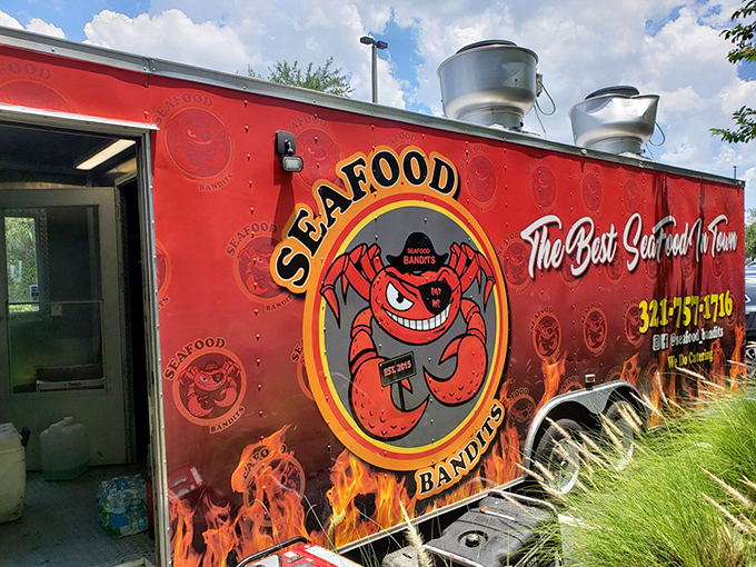 The back of the truck reveals the Bandits' true identity&mdash;a smiling crab mascot who looks like he's plotting delicious crimes against your diet. 