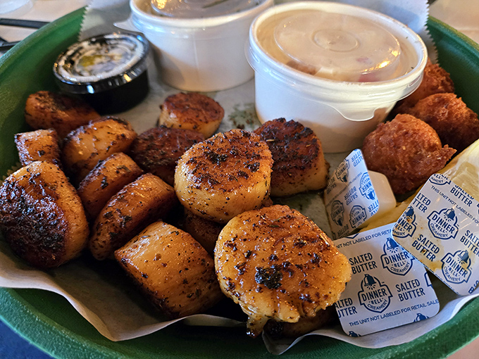 Seared scallops with that perfect caramelized crust alongside hush puppies, because when seafood this fresh meets skillful preparation, magic happens on your plate.