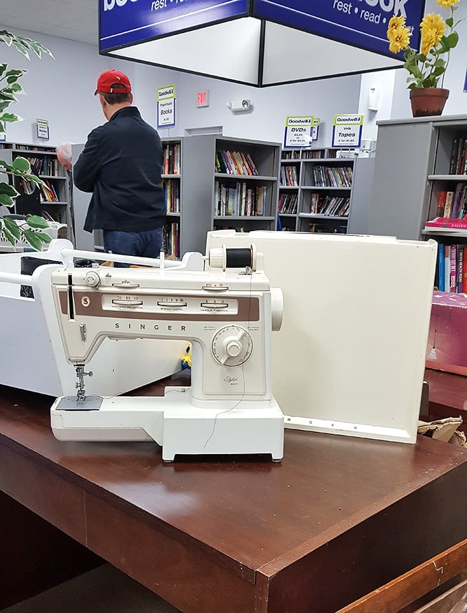 A Singer sewing machine stands ready while a bookworm browses nearby. Two different paths to creativity under one roof.