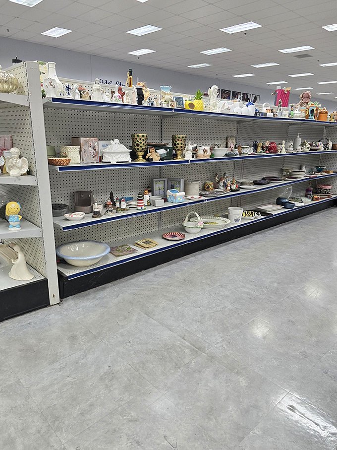 This shelf display showcases the beautiful randomness of thrifting—ceramic figurines and decorative plates telling stories of homes they once adorned.