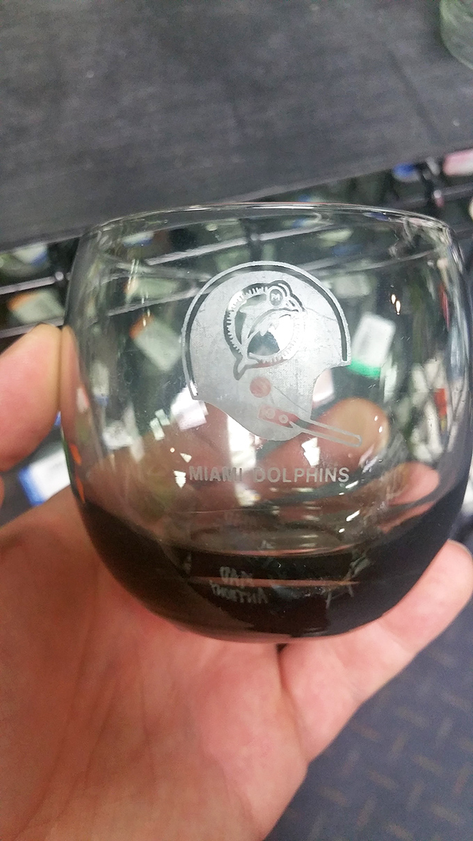 A Miami Dolphins glass waiting for its next football Sunday. Someone's team memorabilia becomes another fan's game day essential.