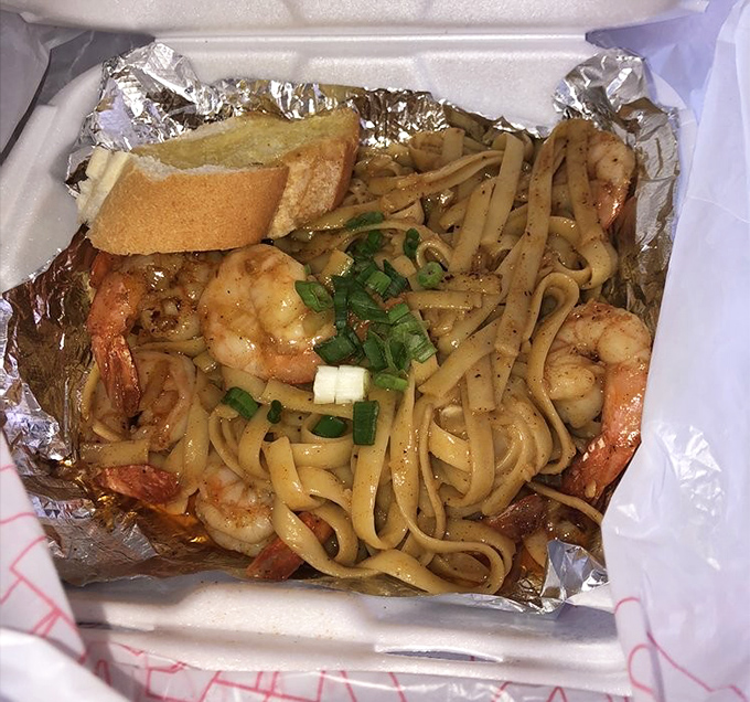 Shrimp and noodles nestled in foil like a present waiting to be unwrapped. Garlic butter sauce transforms simple ingredients into poetry.