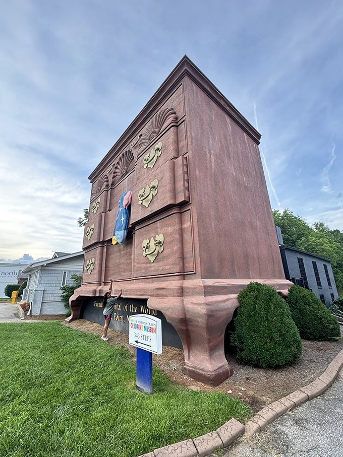 The side view reveals just how this wooden wonder dominates its surroundings. It's like the neighborhood decided to play "one of these things is not like the others."