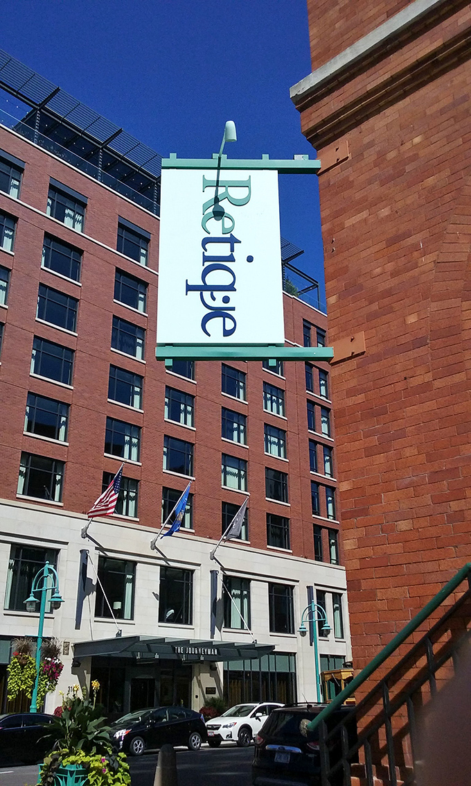 Retique's vertical signage stands tall against Milwaukee's skyline, a beacon for those seeking style without the sticker shock.