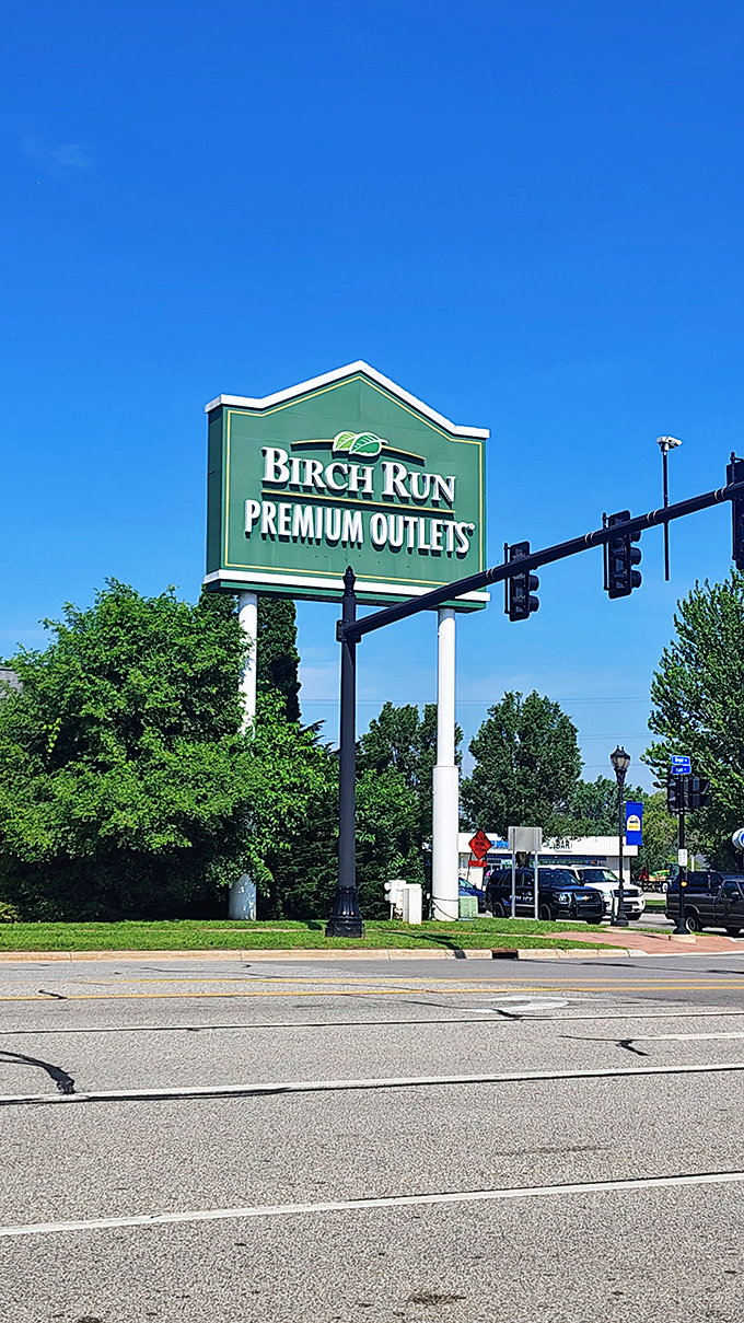 The green beacon of bargain hunters everywhere. Birch Run's iconic sign stands tall against the blue Michigan sky, guiding shoppers home.