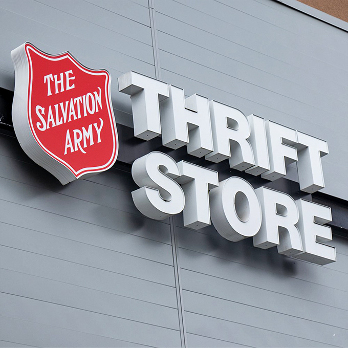The iconic Salvation Army shield stands proud against the sky. A beacon for bargain hunters and philanthropists alike.