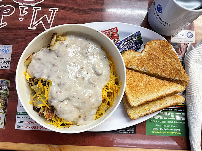 A hearty skillet breakfast drowning in gravy, challenging you to find the bottom while your arteries negotiate surrender terms.