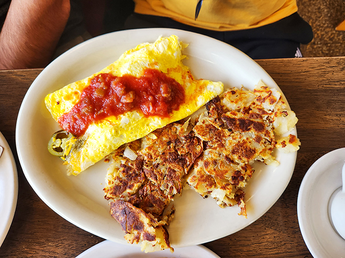 An omelet that's been folded around its fillings like a warm, eggy hug. The home fries aren't a side dish&mdash;they're an essential supporting character.