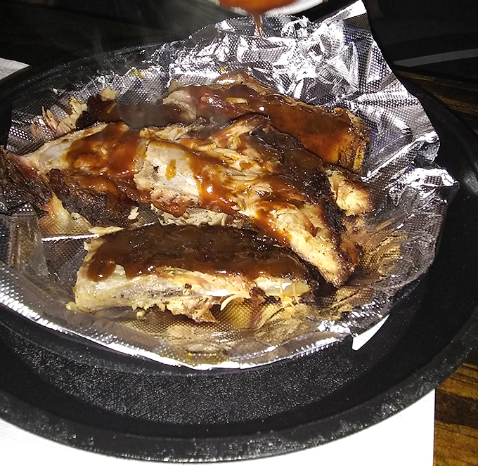 Barbecued ribs glistening with sauce, ready to make you forget about table manners and embrace the primal joy of gnawing on bones.