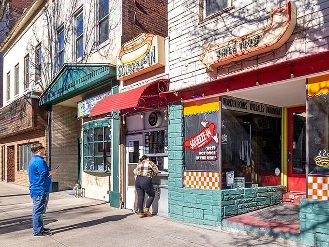 Colorful storefronts house local eateries like Squeeze-In, where affordable comfort food comes with a side of community connection.