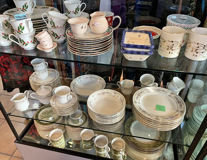China patterns through the decades, stacked with precision. Someone's wedding registry from 1975 is complete again, ready for a second chance at hosting.