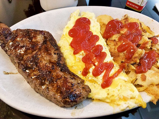 When steak and eggs share a plate, it's not just breakfast&mdash;it's fuel for champions, with a splash of ketchup adding that diner authenticity.