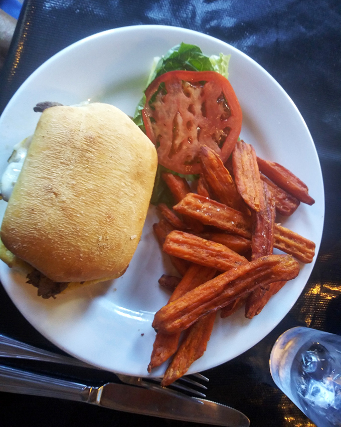 The humble sandwich gets the royal treatment with tender steak, fresh toppings, and those sweet potato fries that somehow make regular fries seem like underachievers.