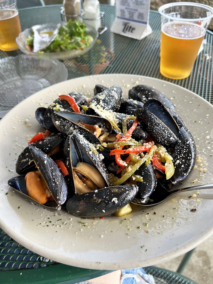 These mussels have dressed for dinner in their blue-black finest, opening up to reveal their secrets in a fragrant bath of garlic and wine.