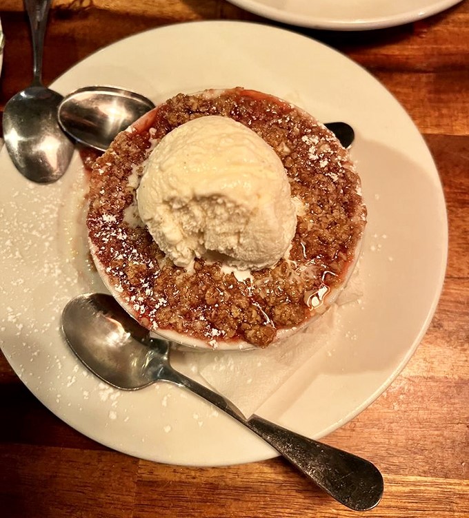 Sweet endings are never an afterthought here. This warm cobbler crowned with melting vanilla ice cream is worth saving room for&mdash;though you rarely do.