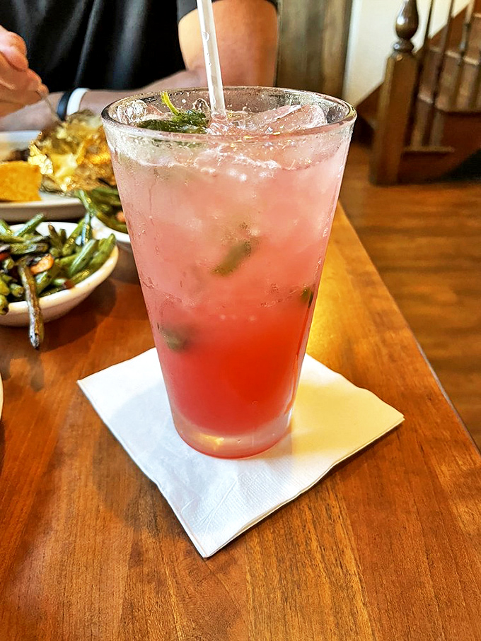 A strawberry mojito that looks like summer in a glass, offering a refreshing counterpoint to all that smoky goodness.