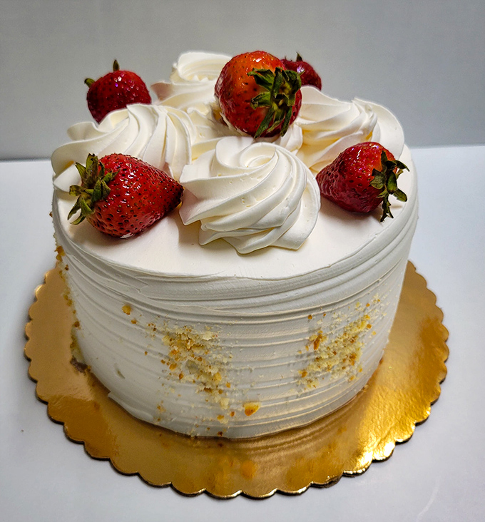 Strawberries and cream: nature's perfect couple, celebrating their relationship atop a cake that deserves its own spotlight.