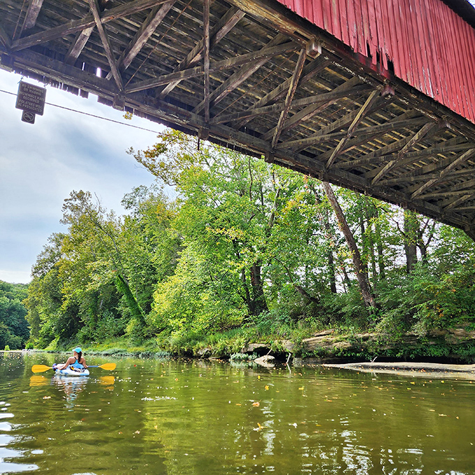 The bridge's impressive span seen from below, where kayakers gain a unique perspective. Architecture appreciation with a splash of adventure.